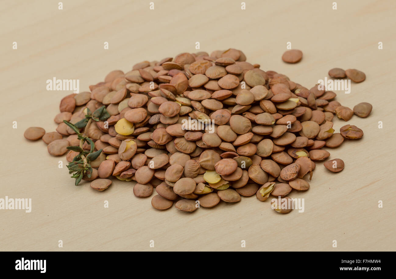 Dry Lentil heap on the wood background Stock Photo - Alamy