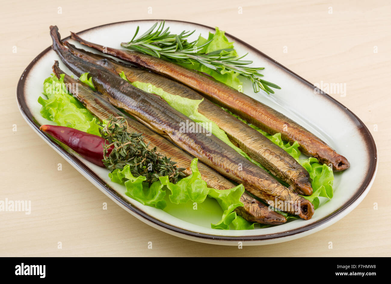 Smoked Lamprey - seafood delicacy with salad and herbs Stock Photo - Alamy