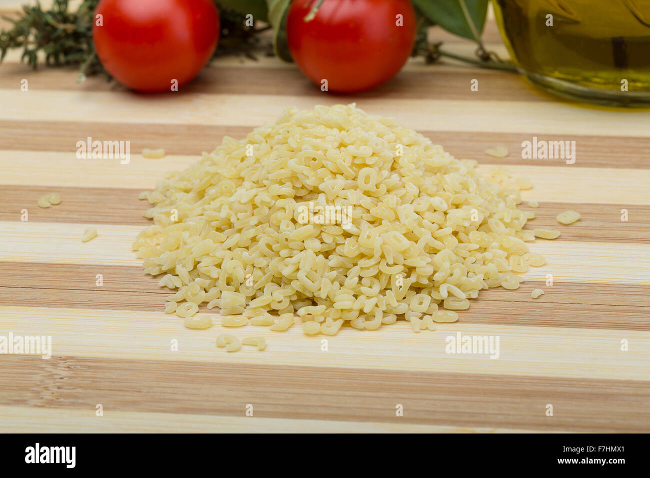 Raw ABC macaroni on the wood background Stock Photo - Alamy