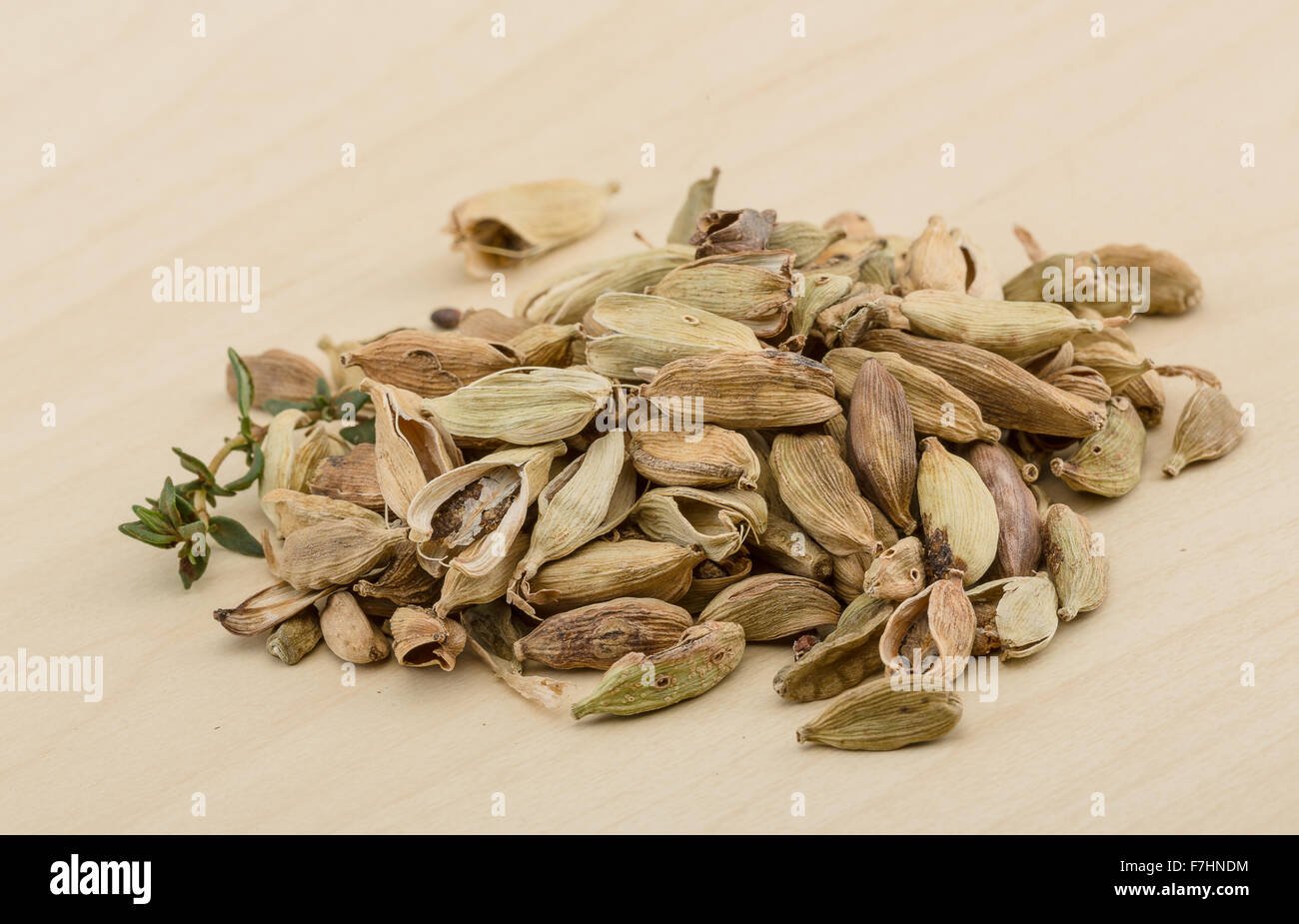 Dry Cardamom heap on the wood background Stock Photo - Alamy