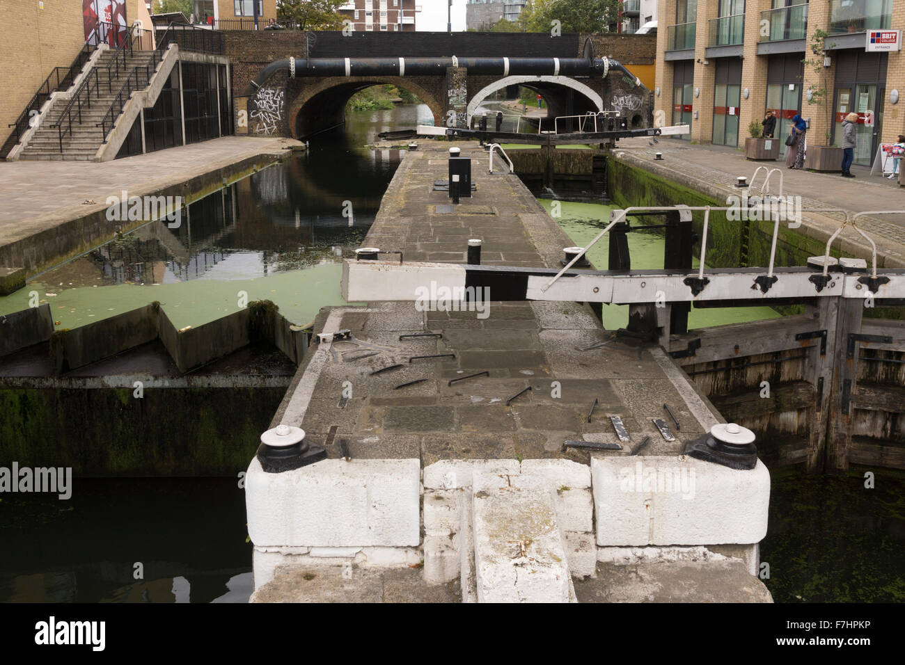 Twin canal locks with lock gates and green algae in the water, just off ...