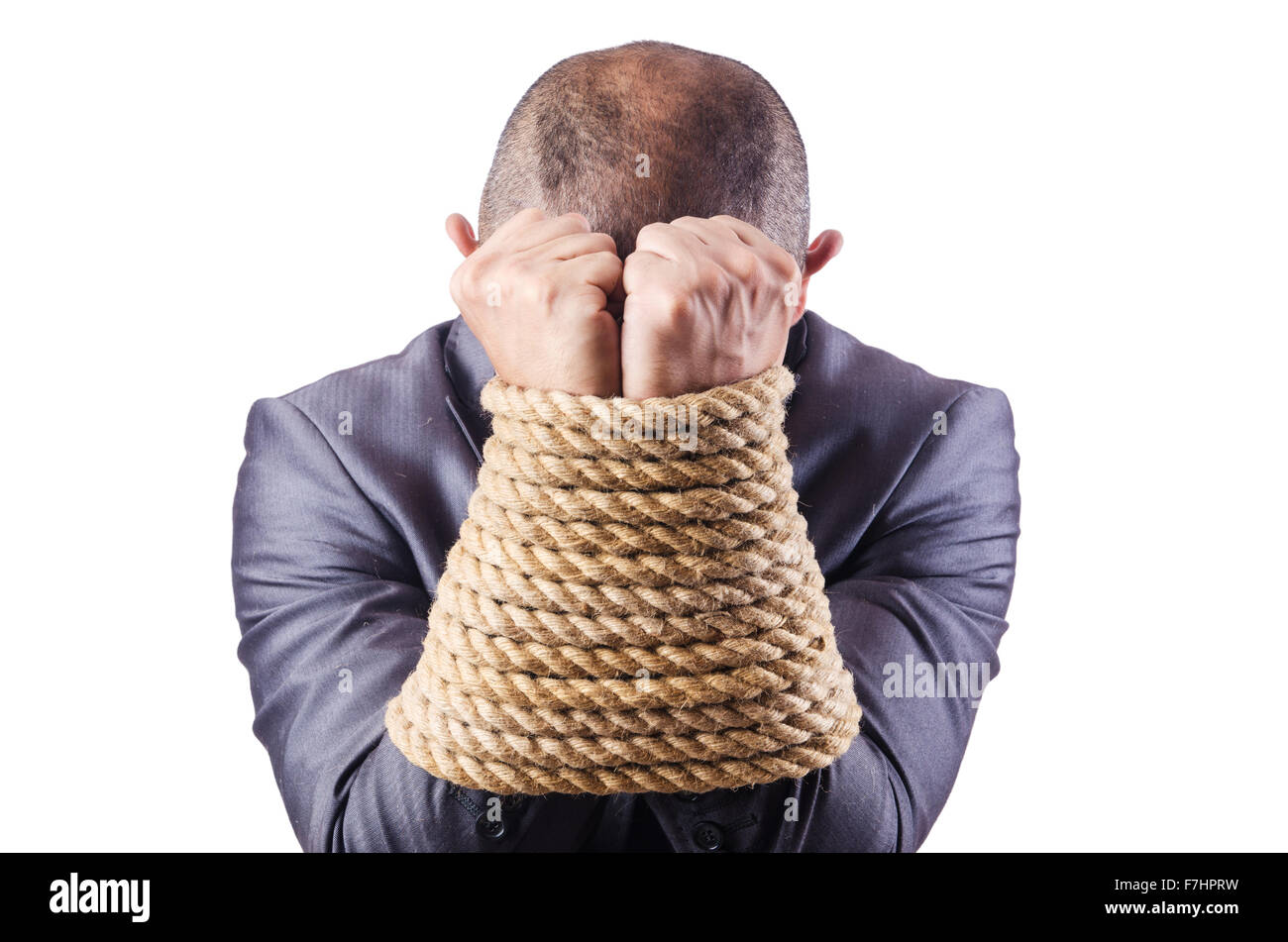 Businessman tied up with rope Stock Photo - Alamy
