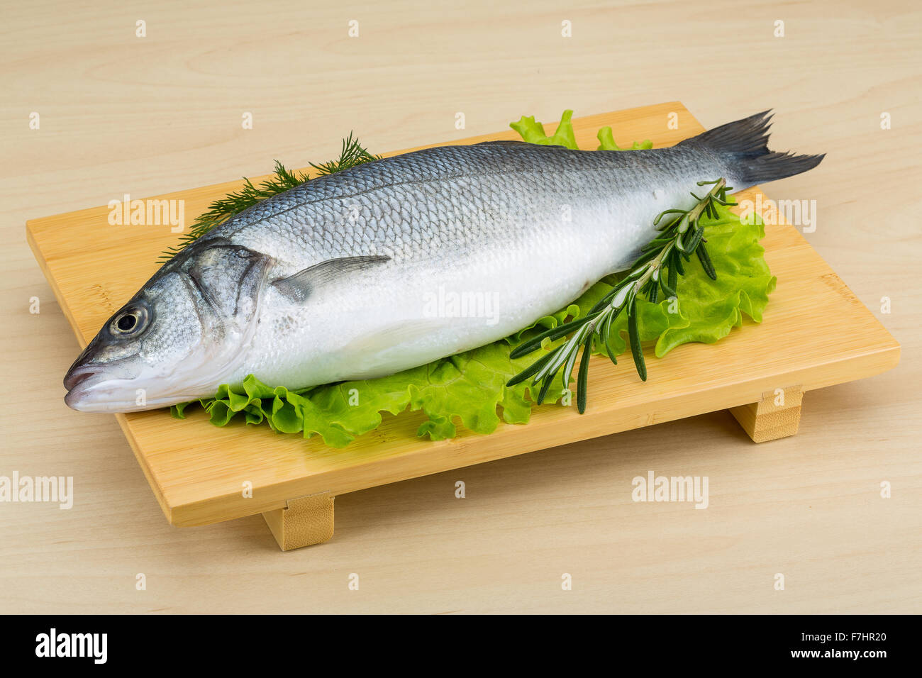 Raw seabass fish with rosemary and dill Stock Photo - Alamy