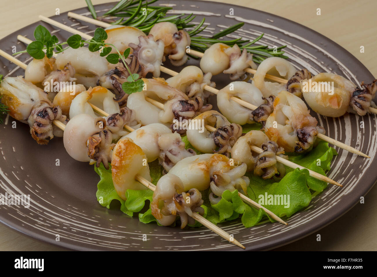 Grilled cuttlefish bbq with rosemary and pepper Stock Photo - Alamy