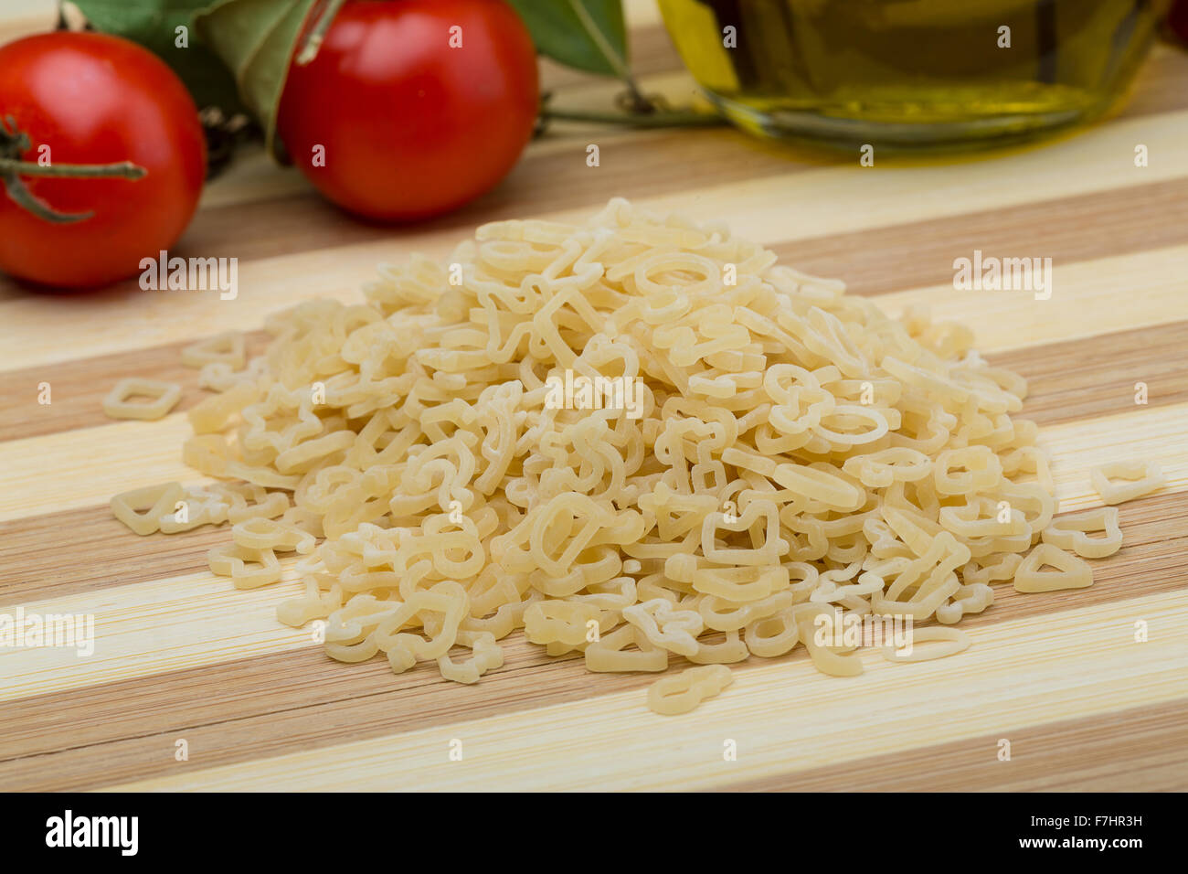 Raw ABC macaroni on the wood background Stock Photo - Alamy