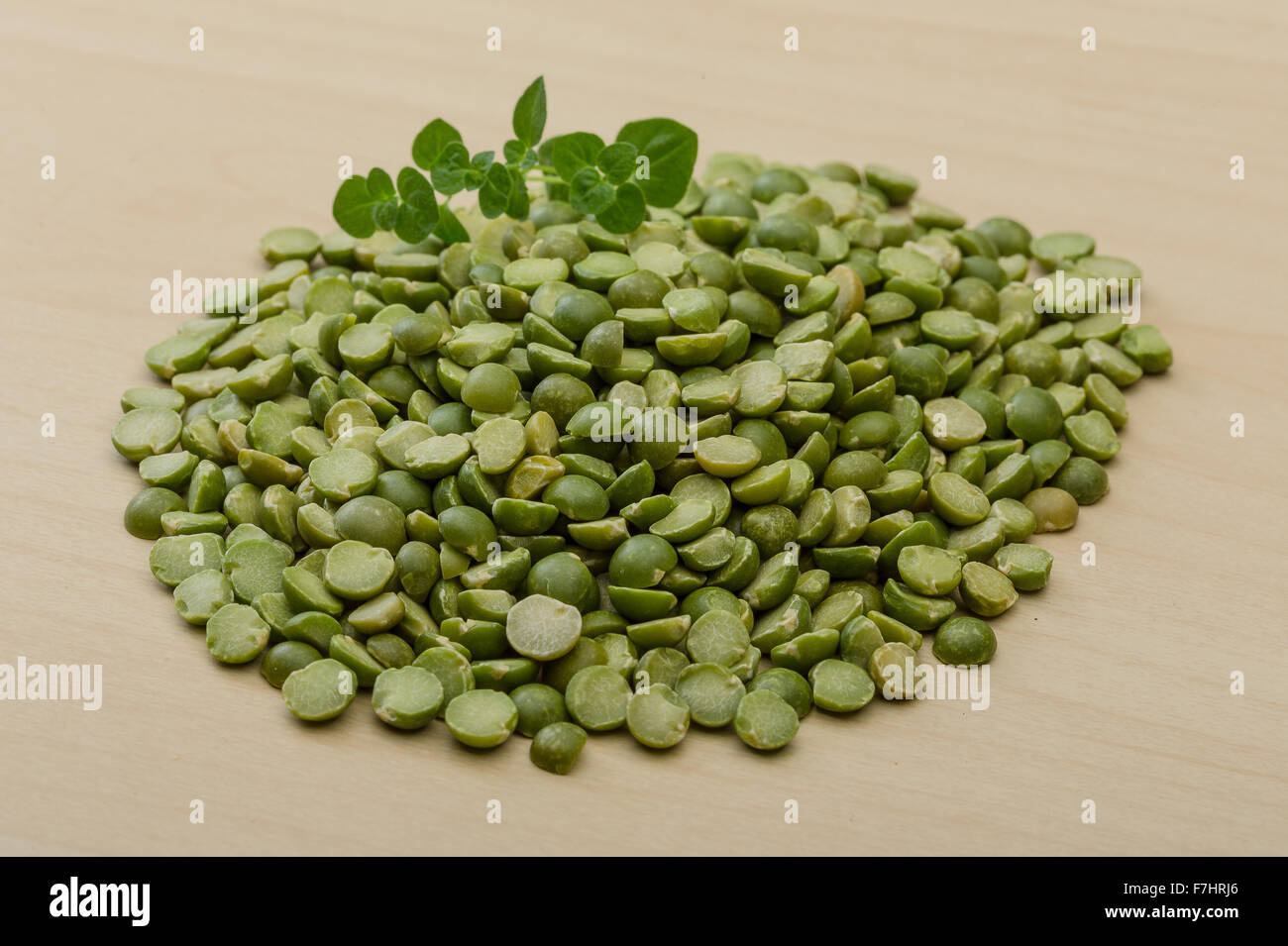 Dry green peas heap on the wood background Stock Photo - Alamy