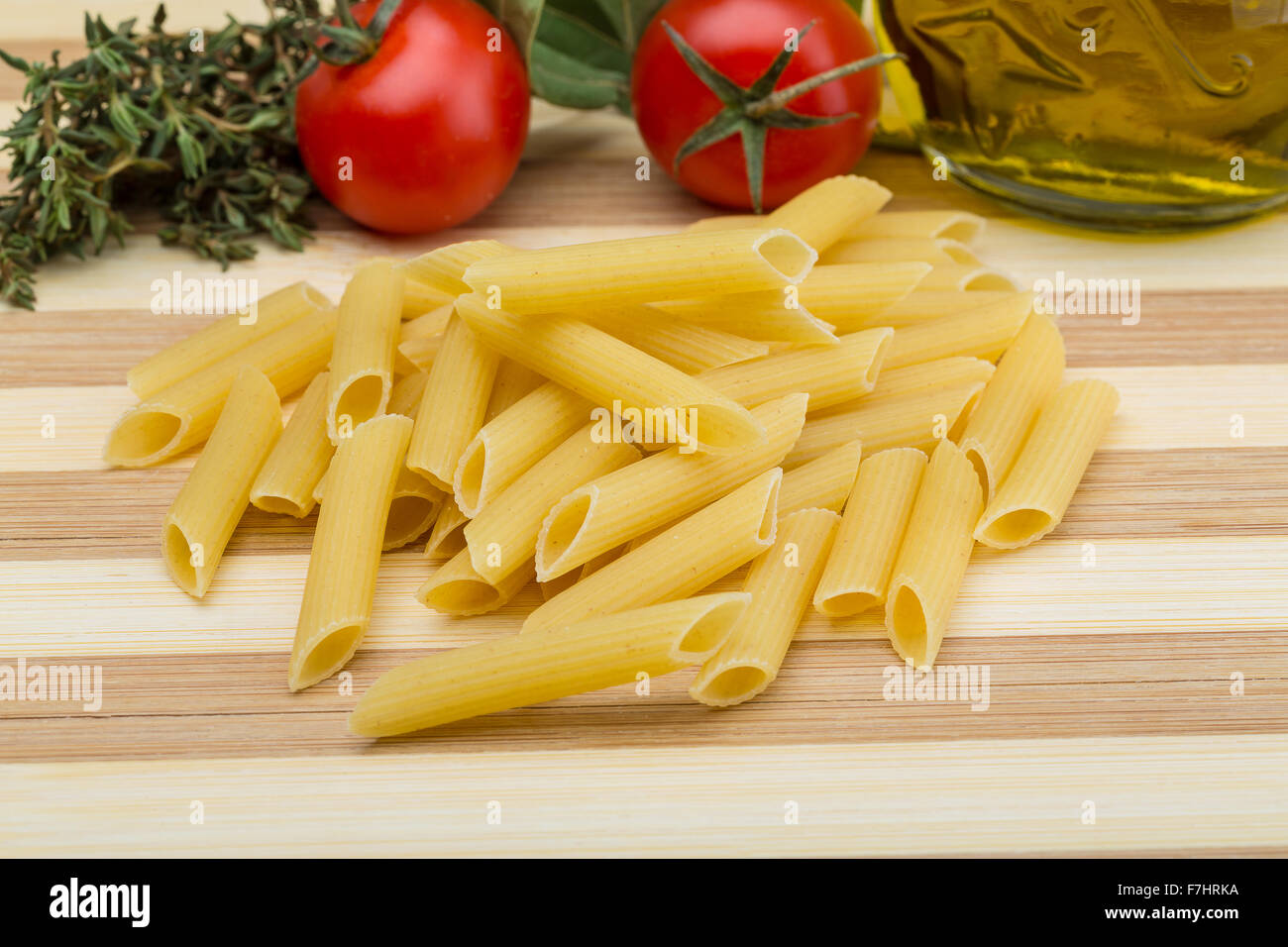 Raw penne pasta on the wood background Stock Photo - Alamy