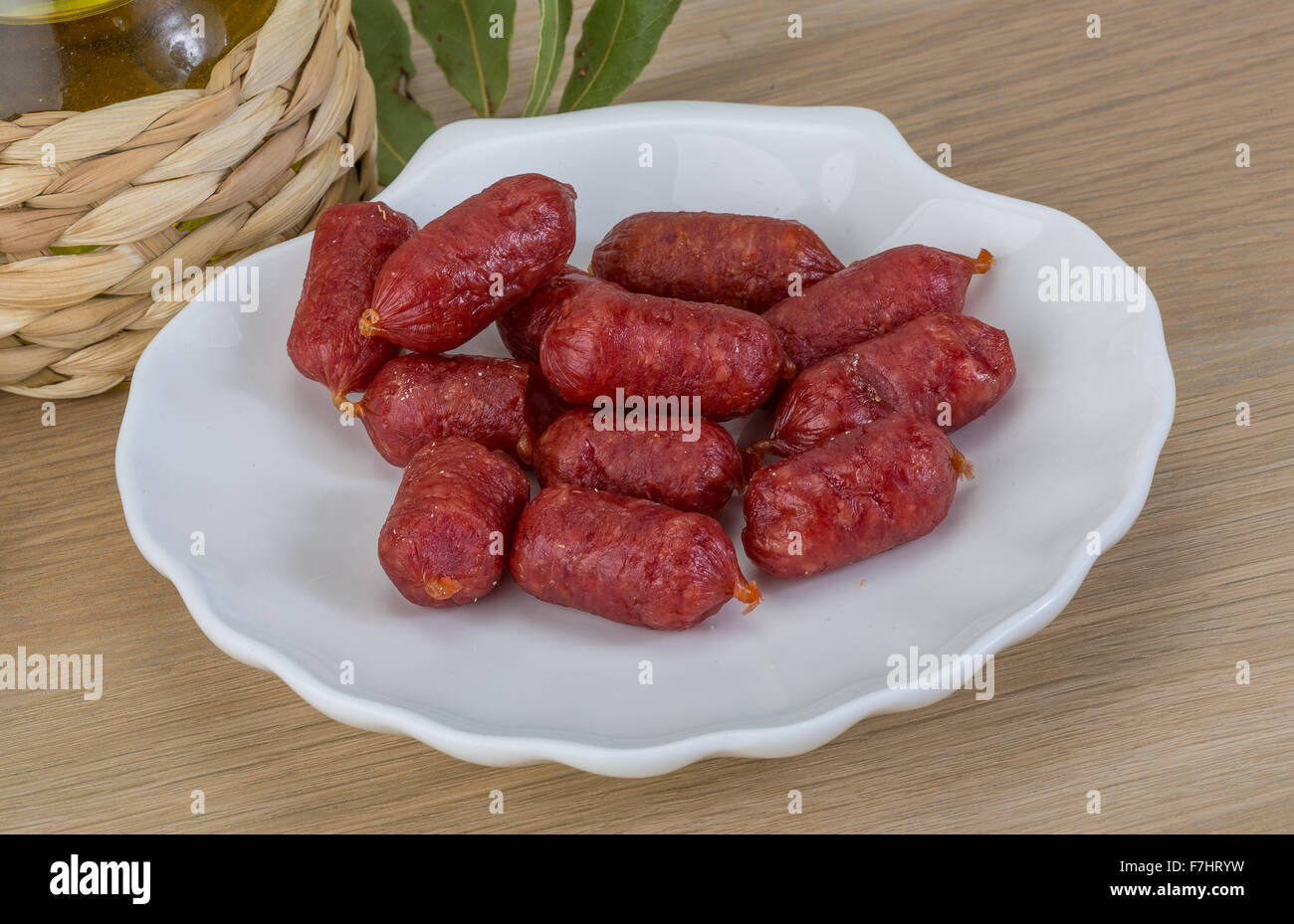 Mini salami sausage on the wood background Stock Photo - Alamy
