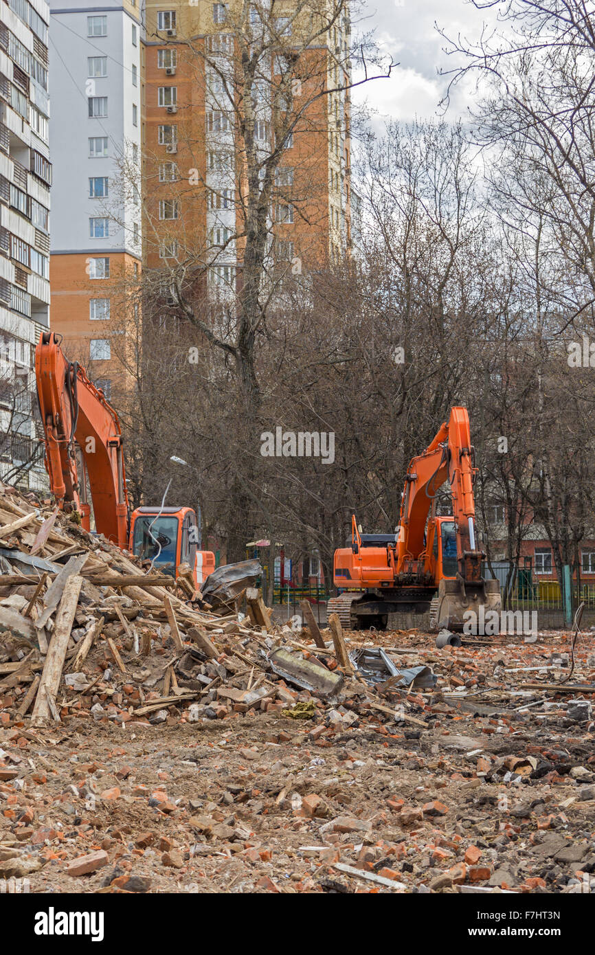 crawler excavator removes construction waste after building demolition ...