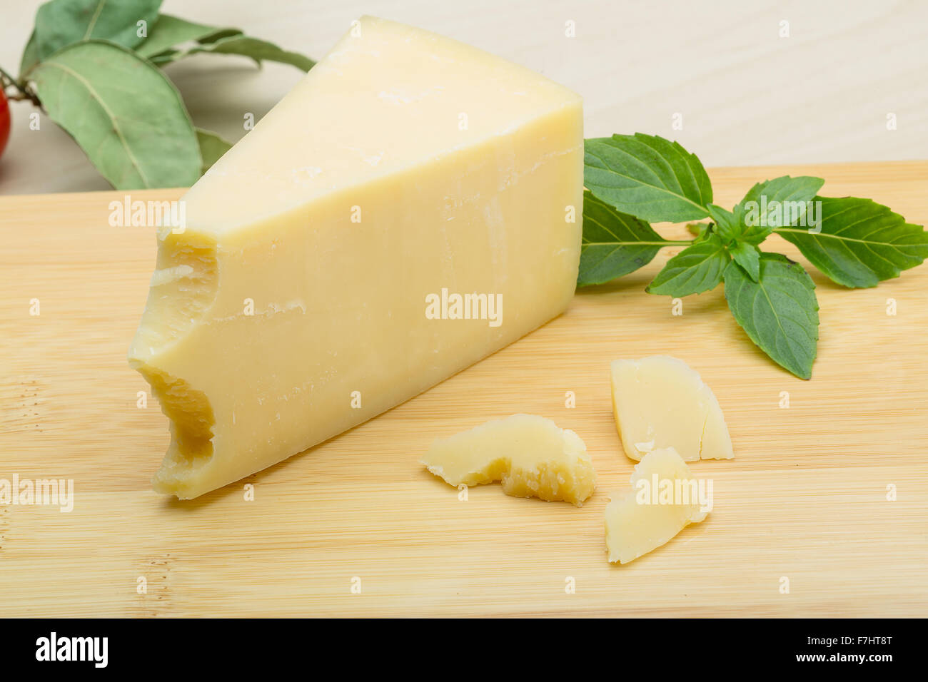 Parmesan cheese with basil leaves on the wood background Stock Photo ...
