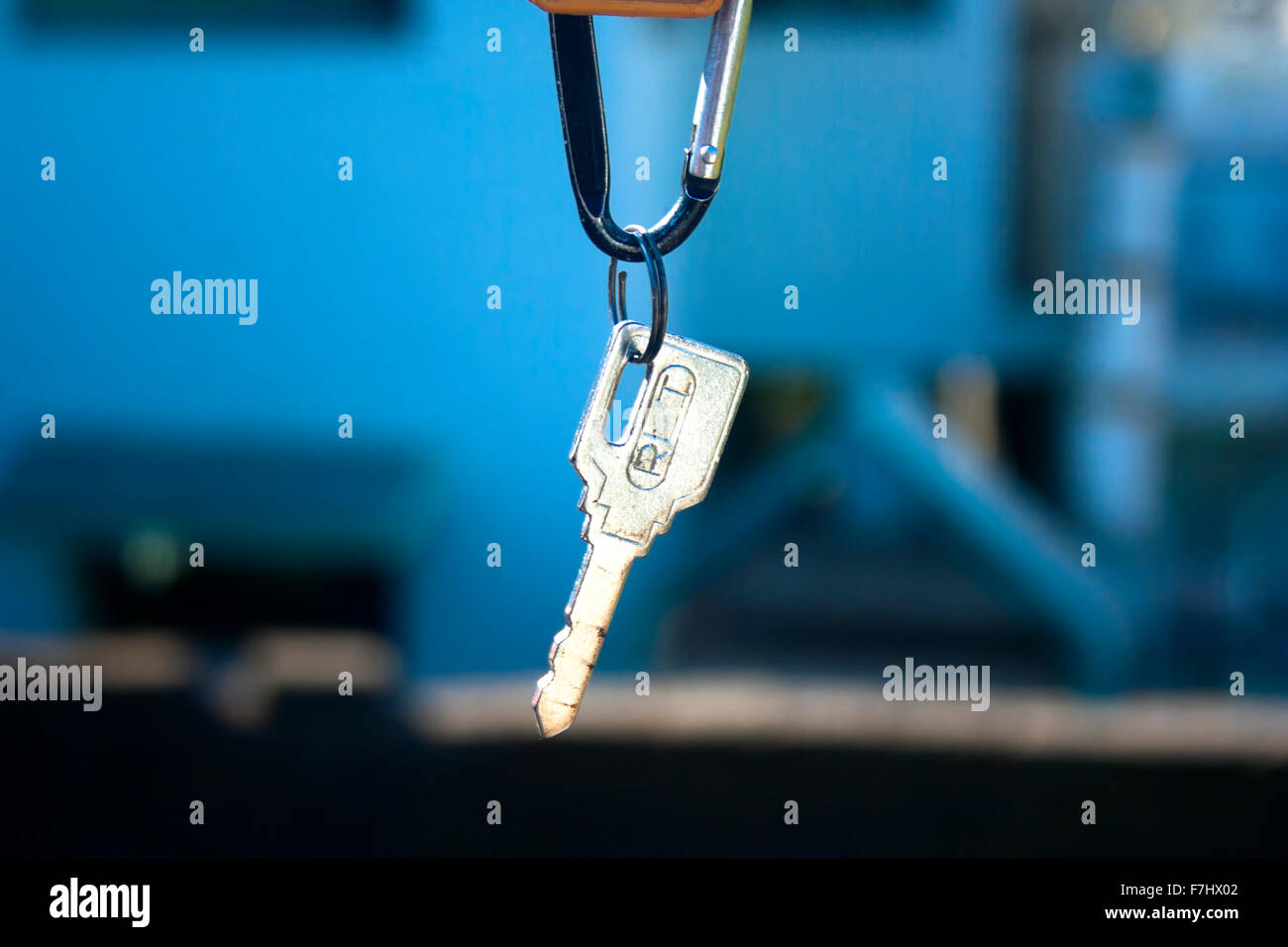 Close-up of a Key hanging through a key chain hook Stock Photo - Alamy