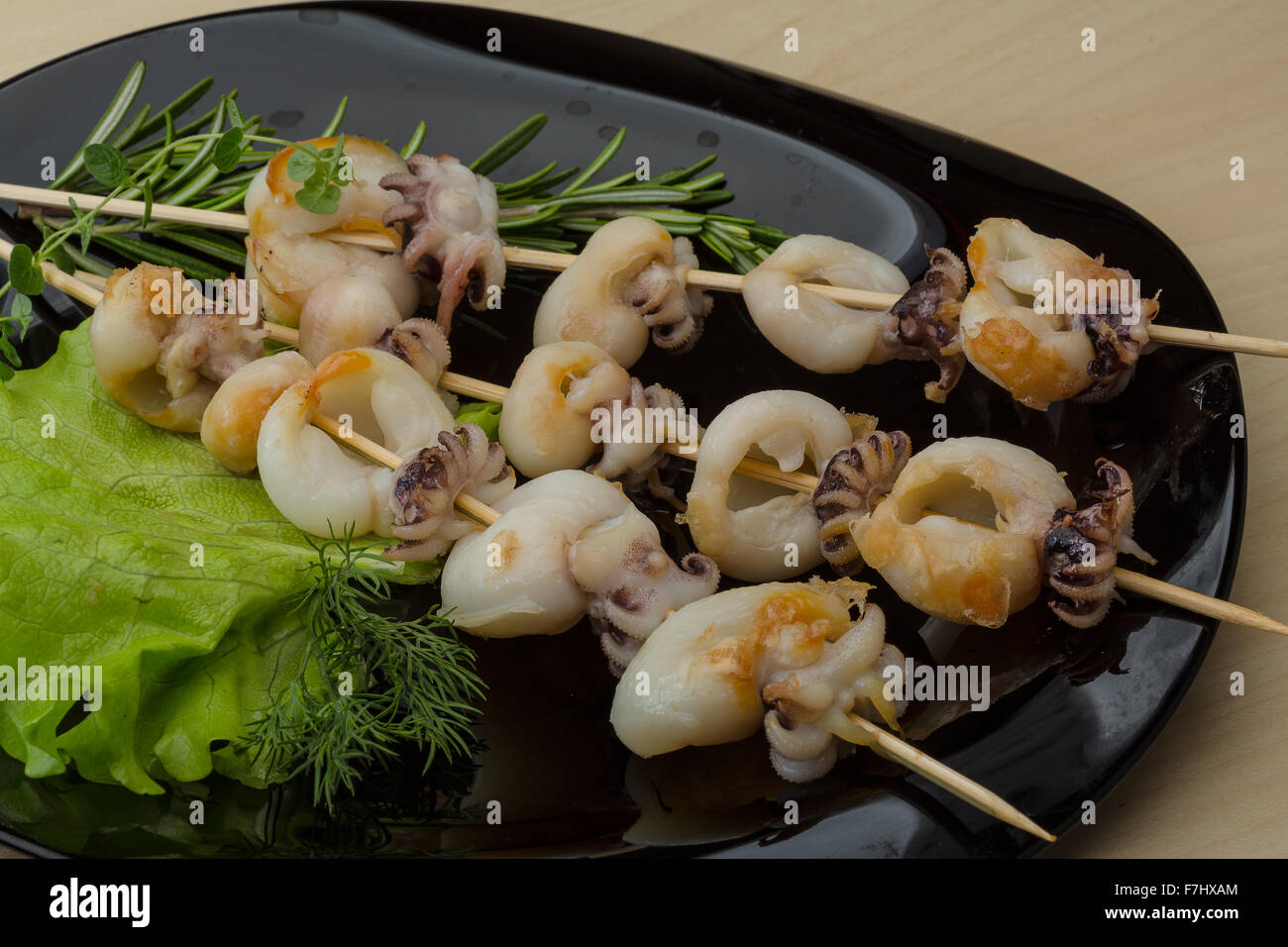 Grilled cuttlefish bbq with rosemary and pepper Stock Photo - Alamy
