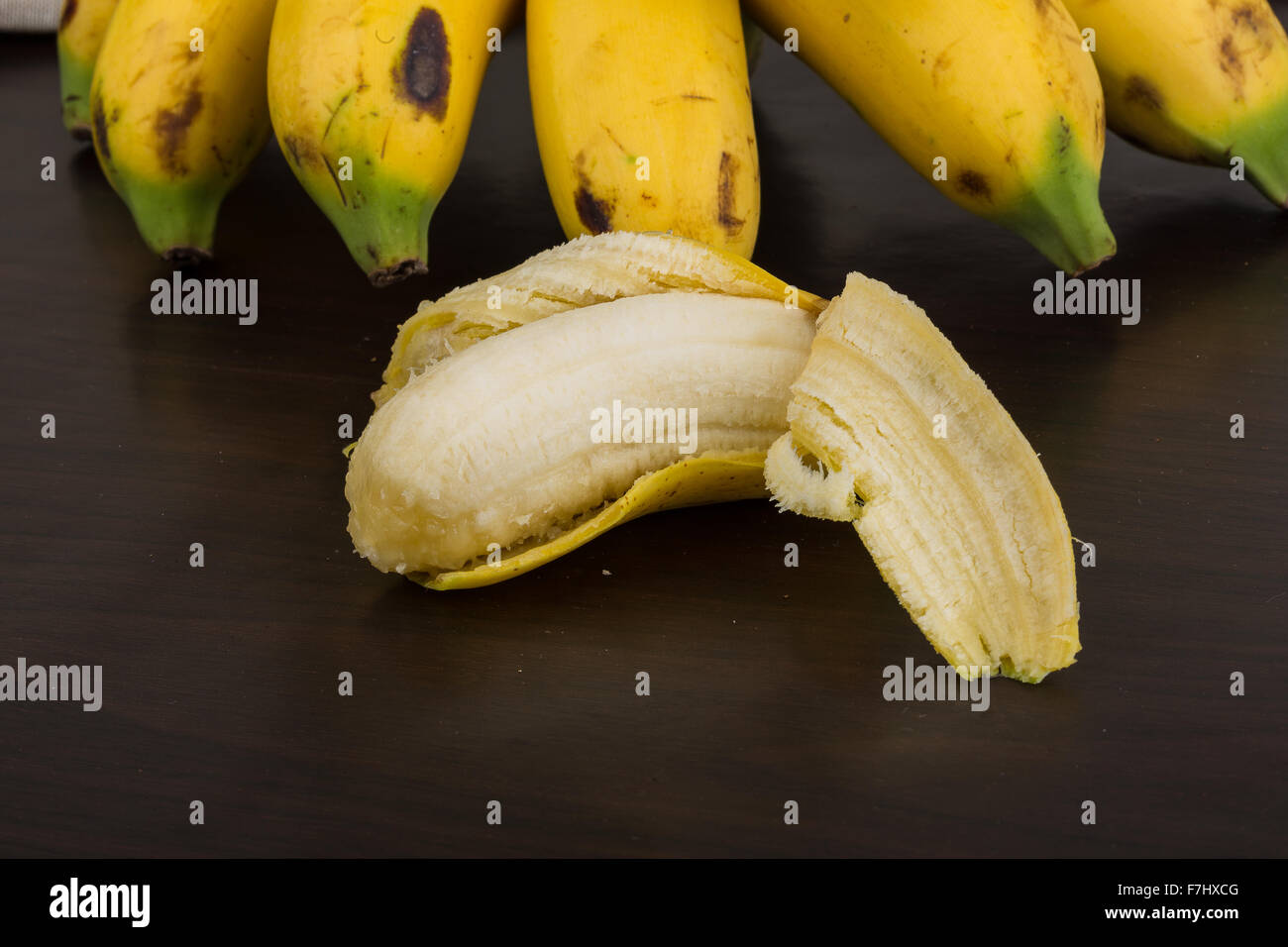 Fresh Baby bananas on the wood background Stock Photo - Alamy