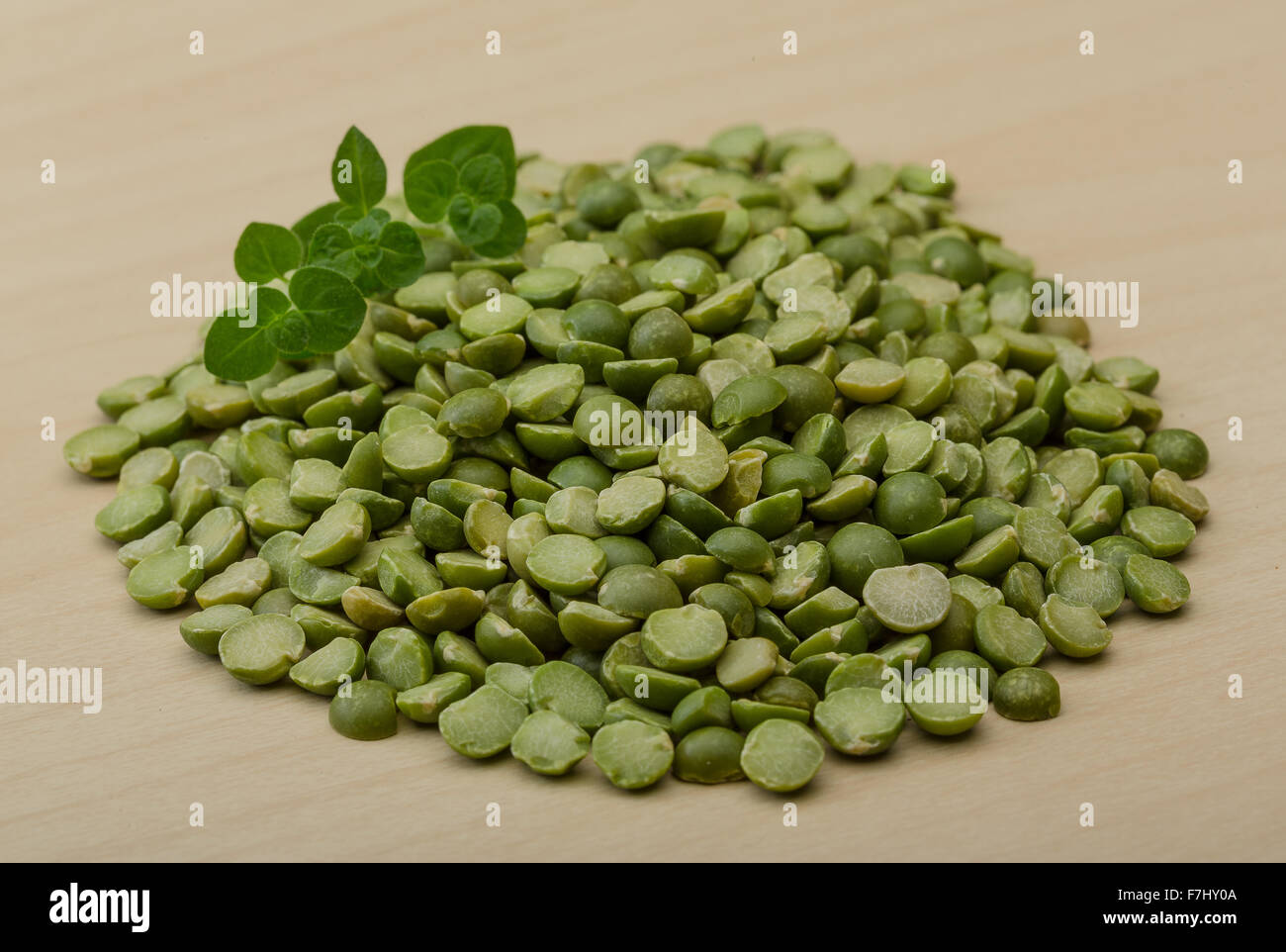 Dry green peas heap on the wood background Stock Photo - Alamy