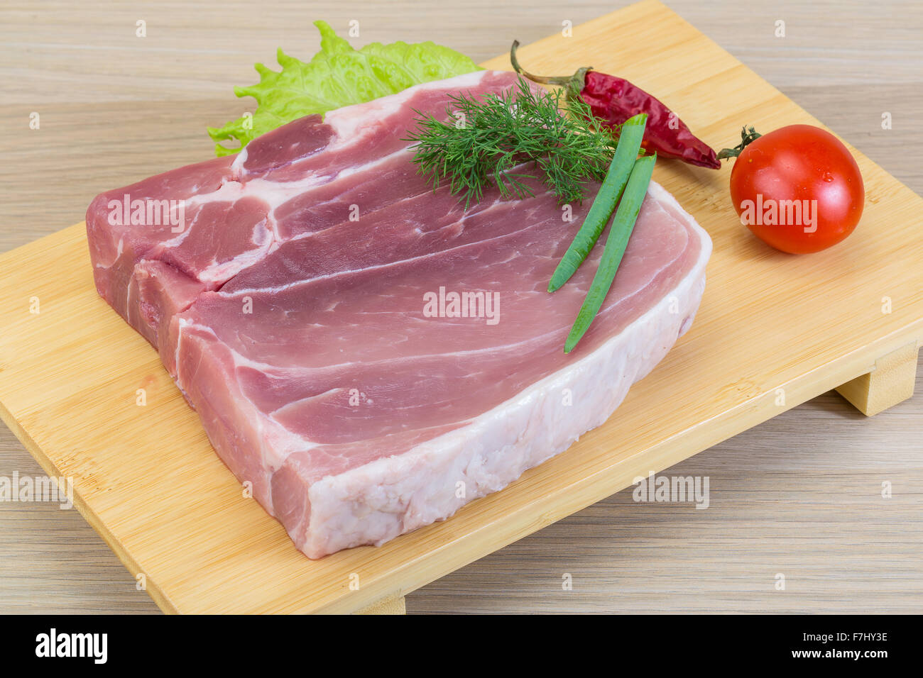 Raw pork meat ready for cooking with herbs Stock Photo - Alamy
