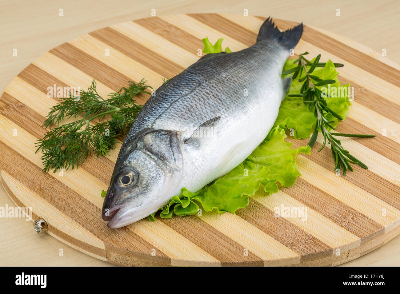 Raw seabass fish with rosemary and dill Stock Photo - Alamy