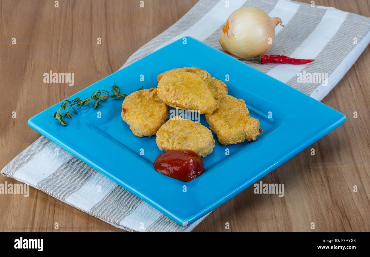 Chicken Nuggets in the blue plate with sauce Stock Photo - Alamy