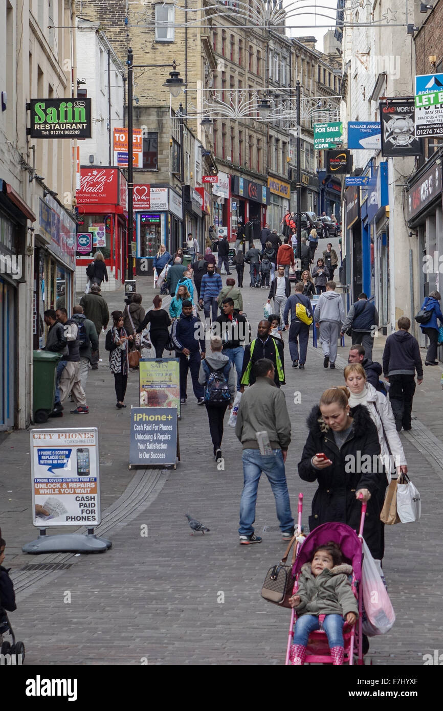 Ivegate Bradford, woman with stroller pushchair in foreground, crowd ...