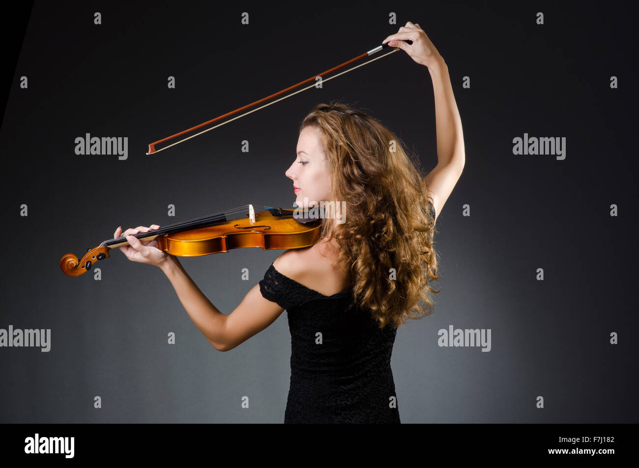Attractive woman with cello in studio Stock Photo - Alamy