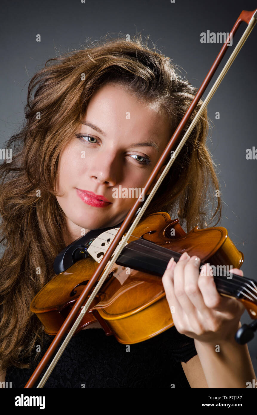 Attractive woman with cello in studio Stock Photo - Alamy