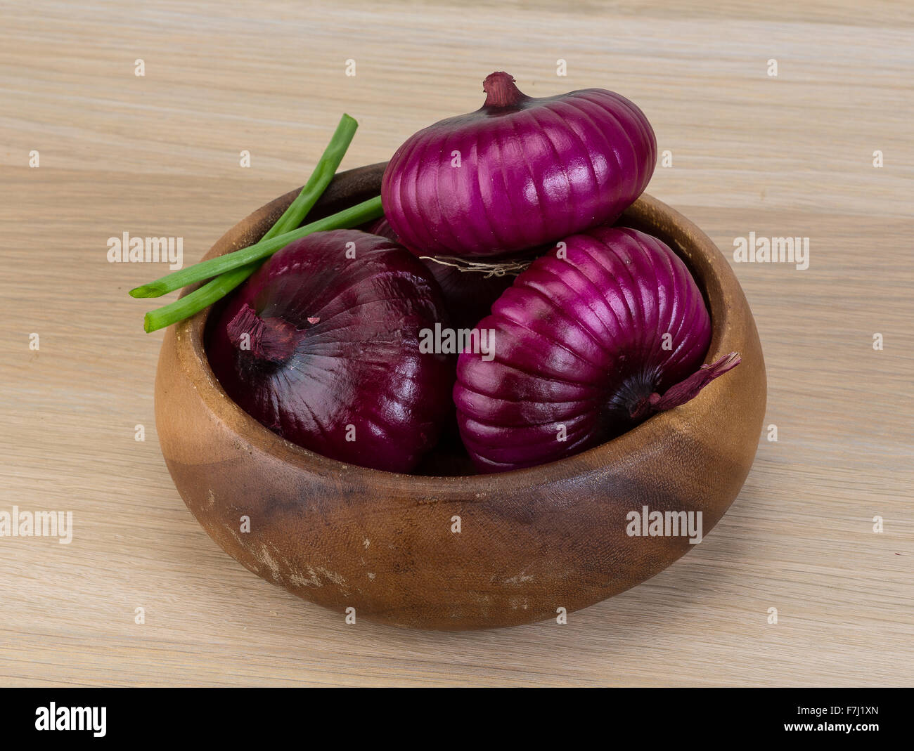 Violet onion in the basket with green Stock Photo - Alamy