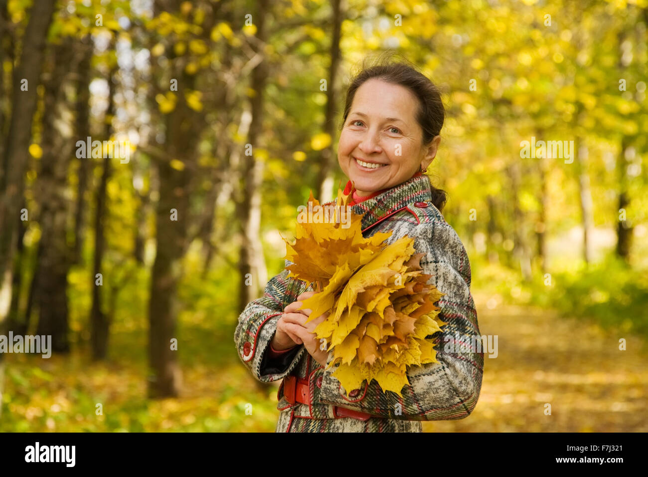 Portrait of mature woman against autumn landscape Stock Photo - Alamy
