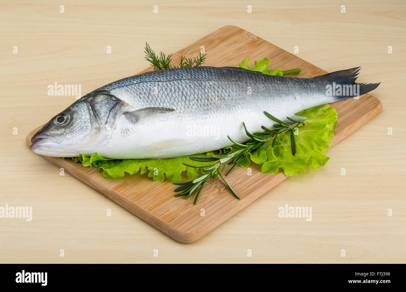 Raw seabass fish with rosemary and dill Stock Photo - Alamy