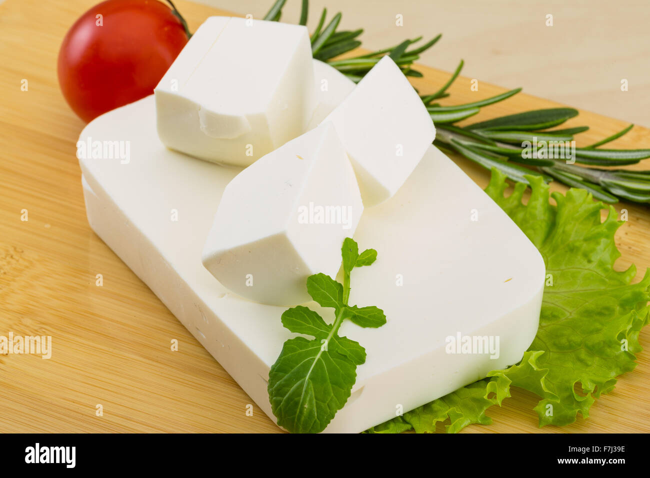 Traditional Greek Feta cheese with salad leaves Stock Photo - Alamy