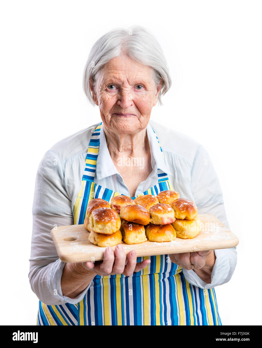 Senior woman holding fresh buns over white Stock Photo - Alamy