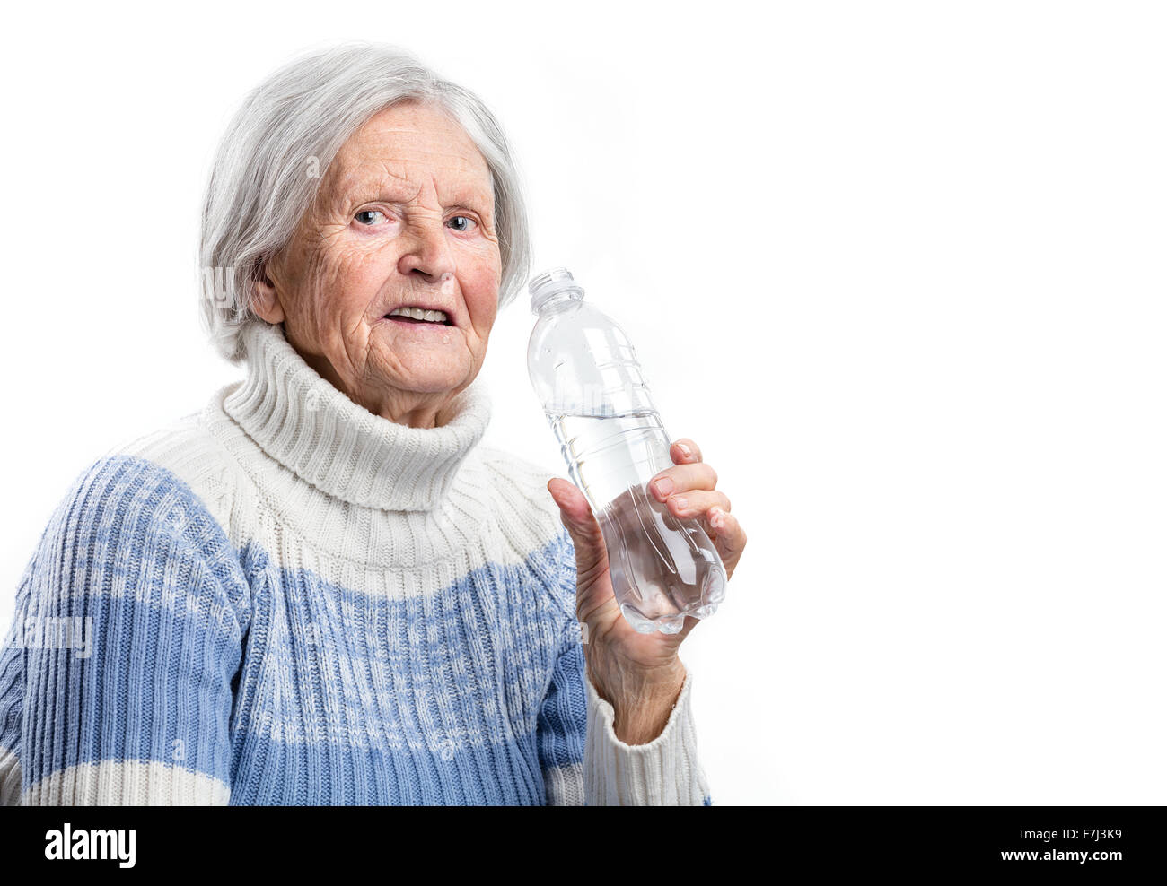 Senior woman with a bottle of water over white background Stock Photo ...