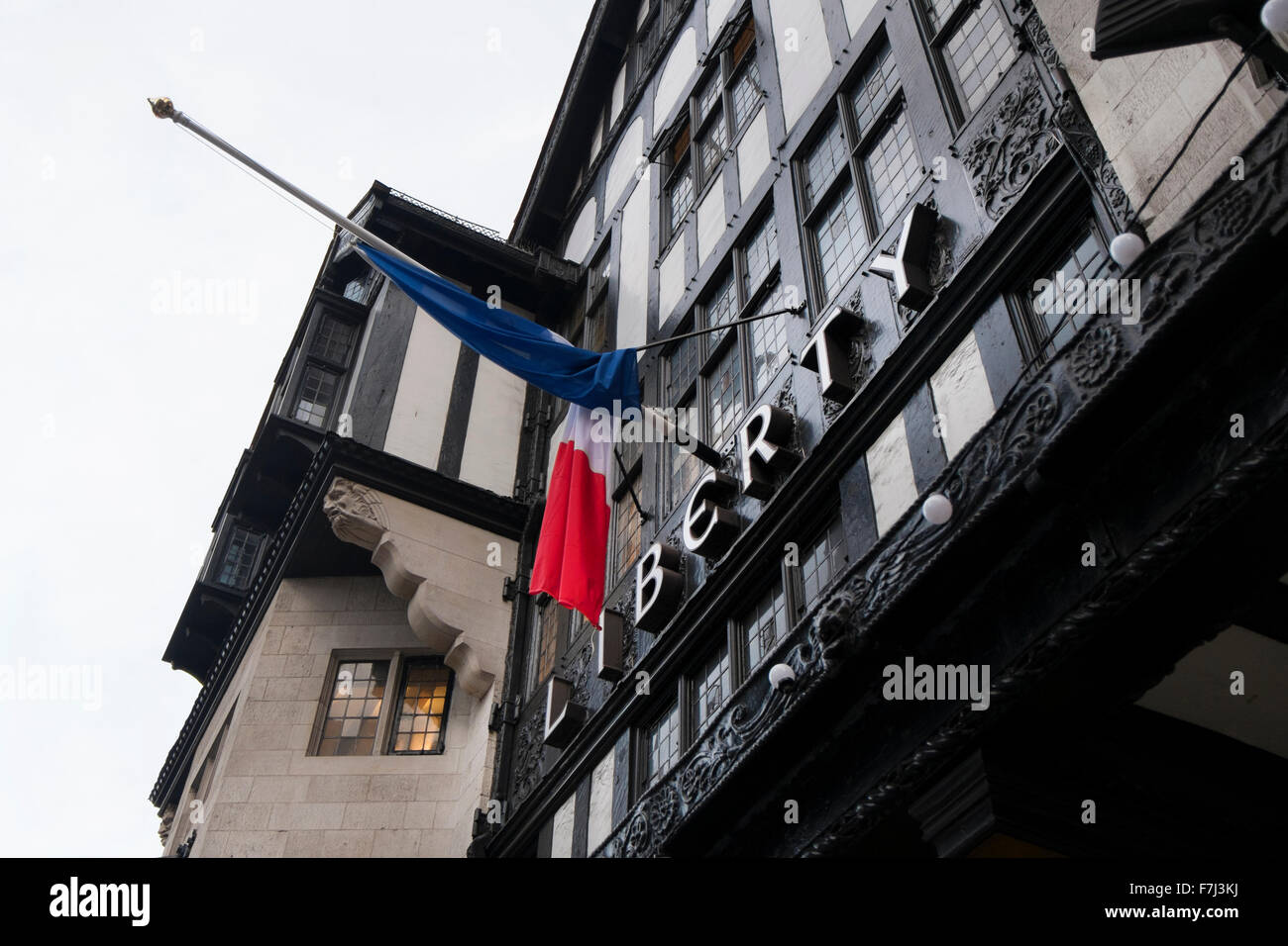 The French tricolore flag flying half mast over the entrance to Liberty ...