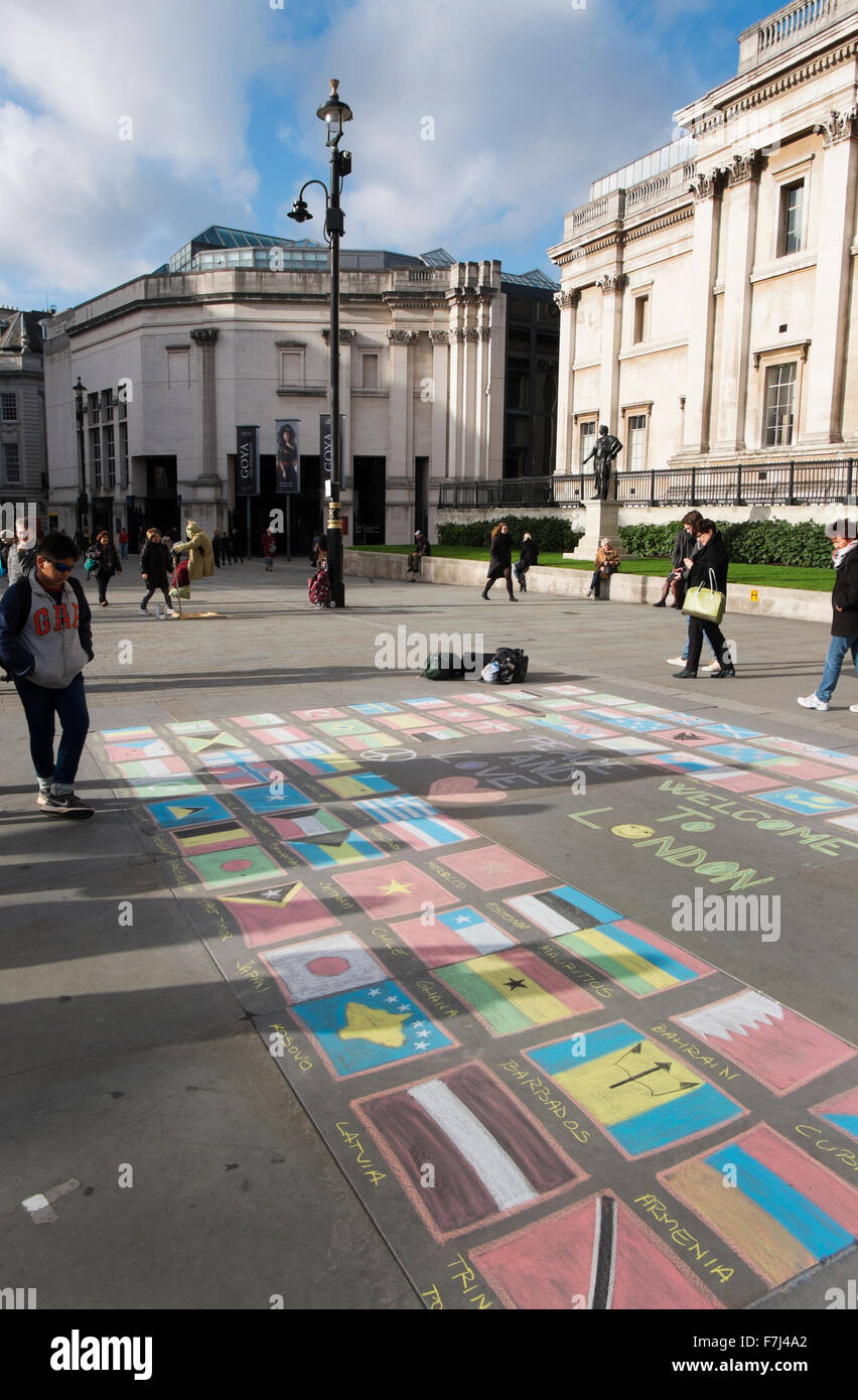 Street performer drawing the flags of the world in chalk on the ...