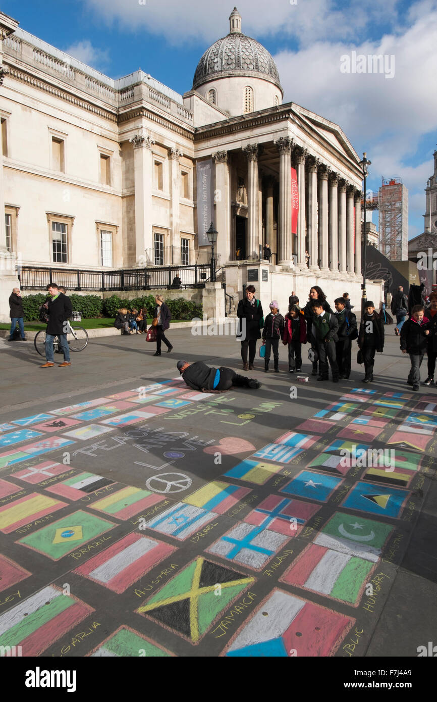 Street performer drawing the flags of the world in chalk on the ...