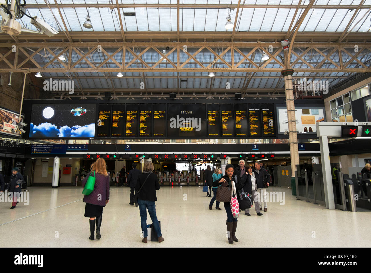A woman standing on the concourse at Charing Cross railway station ...