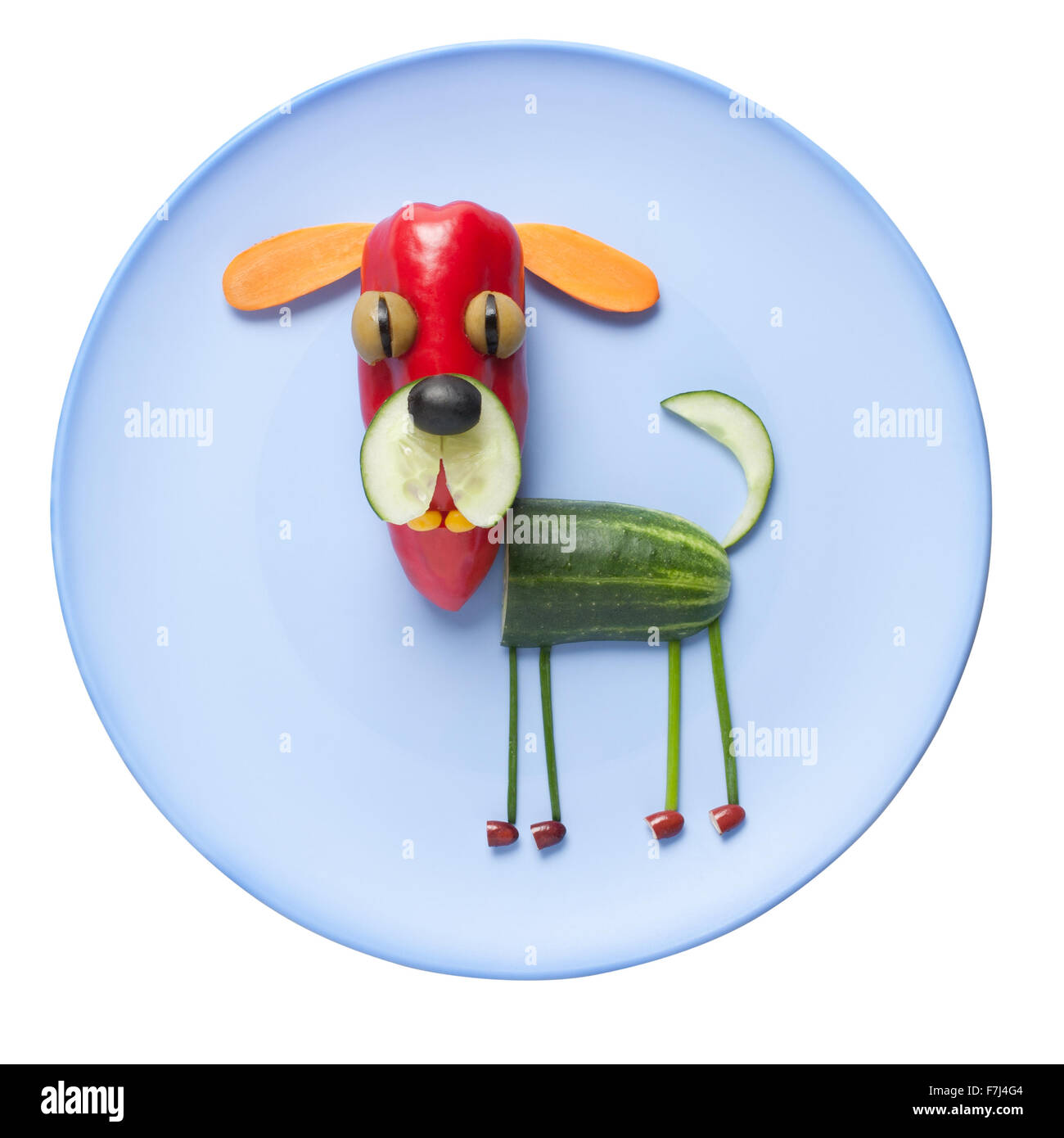 Funny vegetable dog on blue plate Stock Photo - Alamy