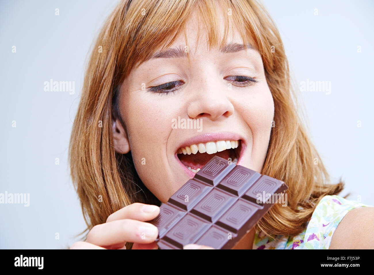 WOMAN EATING SWEETS Stock Photo - Alamy