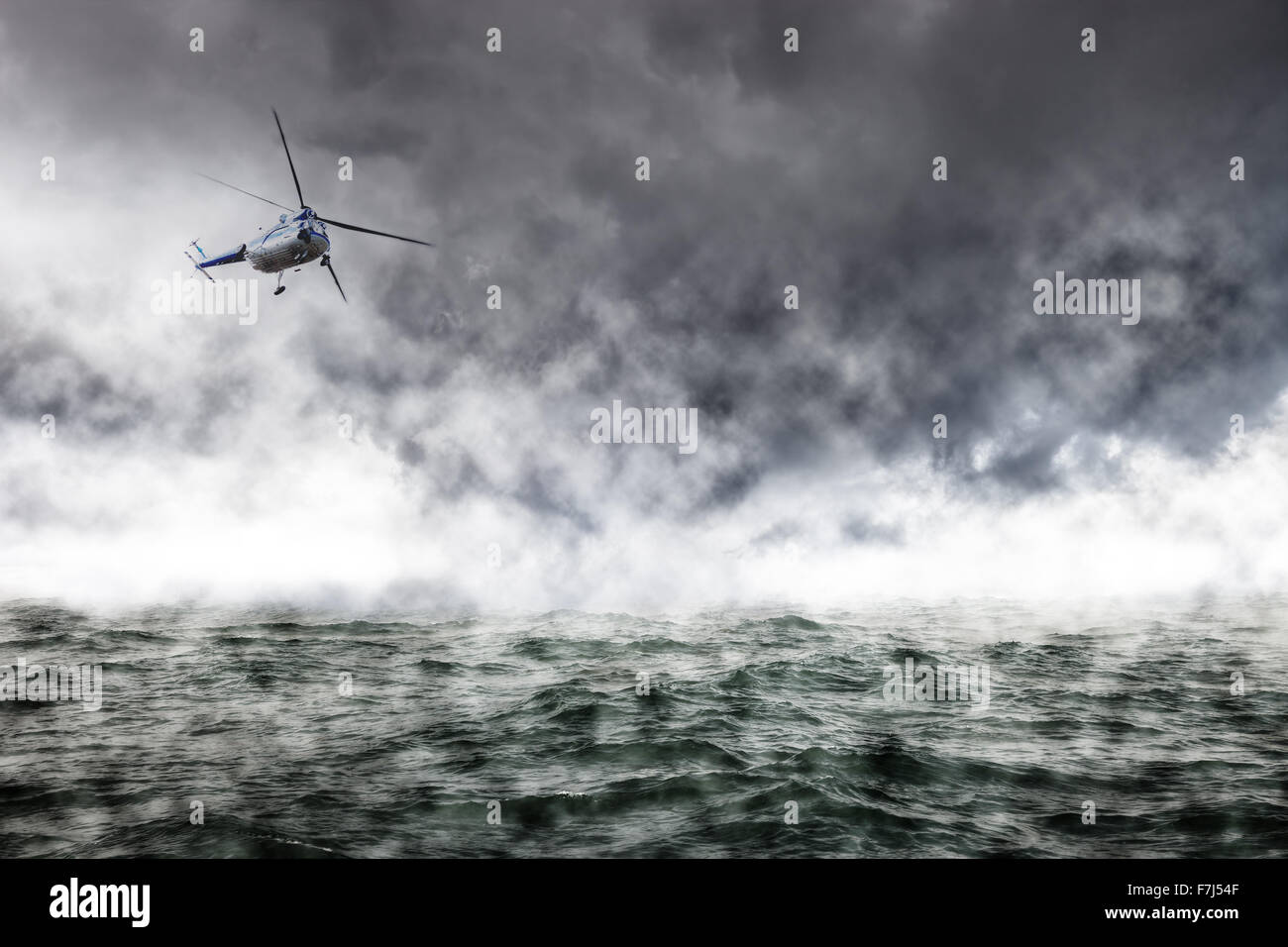 A helicopter rescue mission in difficult stormy weather at sea Stock ...