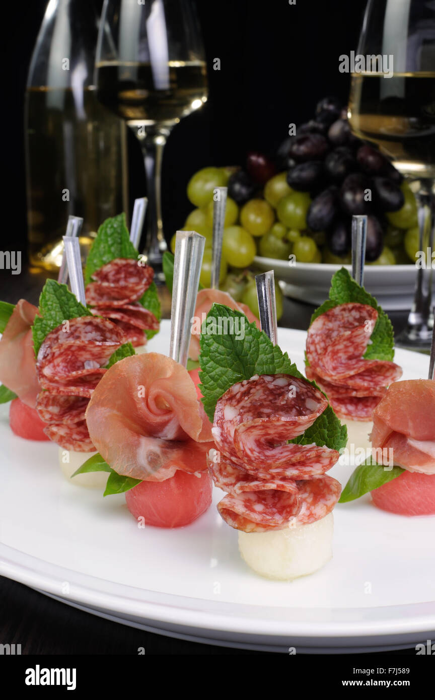 Canape of watermelon balls with a melon with gammon and salami Stock ...