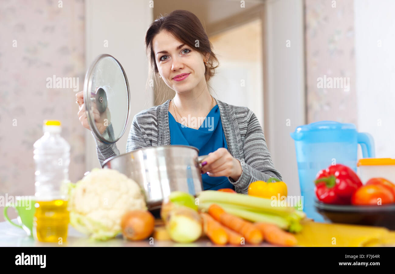 beautiful woman cooking vegetarian lunch in kitchen at home Stock Photo ...