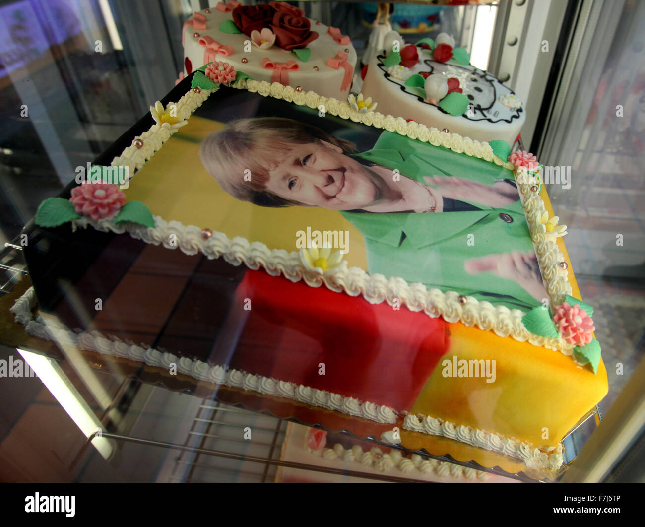 A cake featuring a picture of German Chancellor Angela Merkel and ...