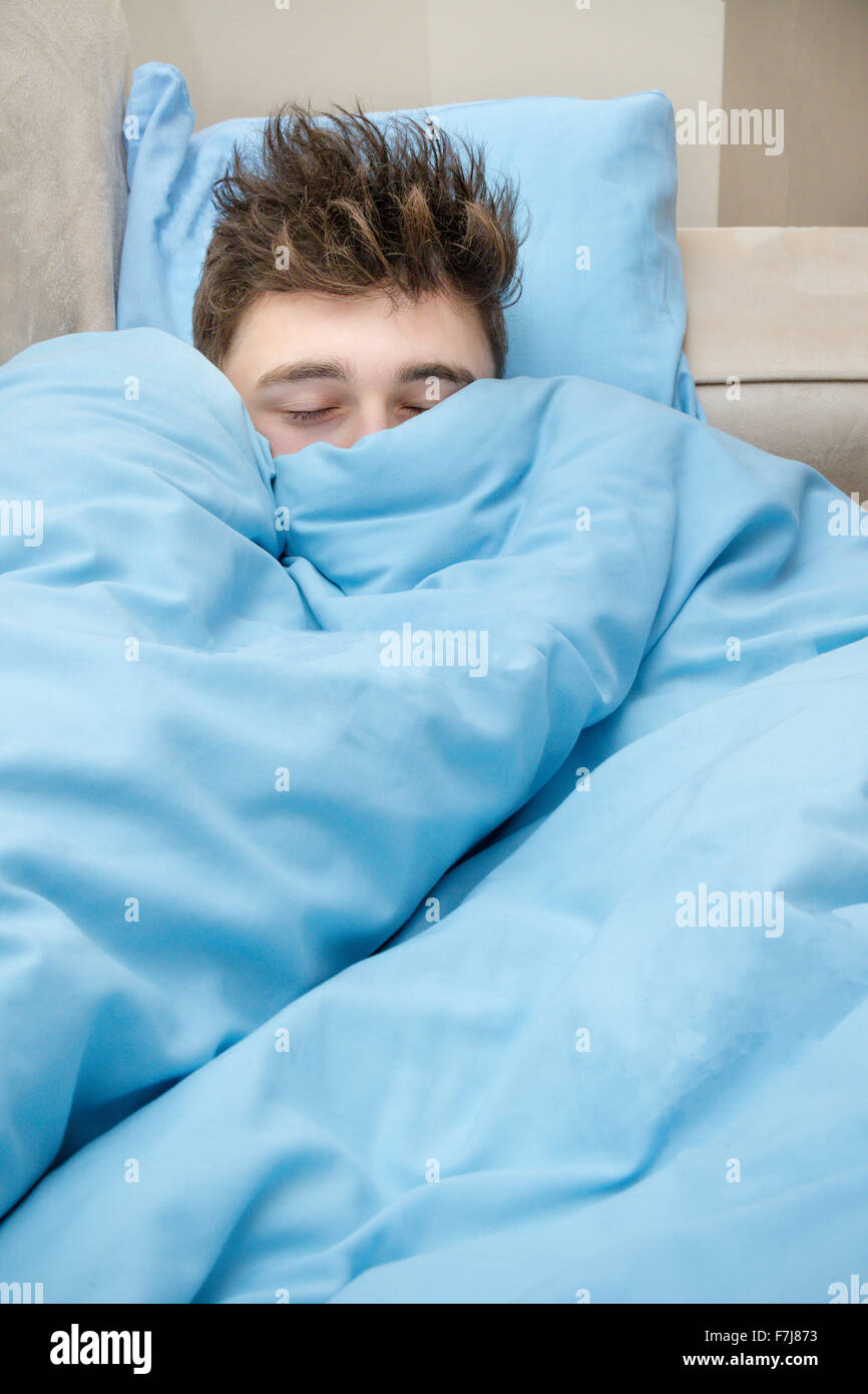 Teen boy sleeping on couch hi-res stock photography and images - Alamy