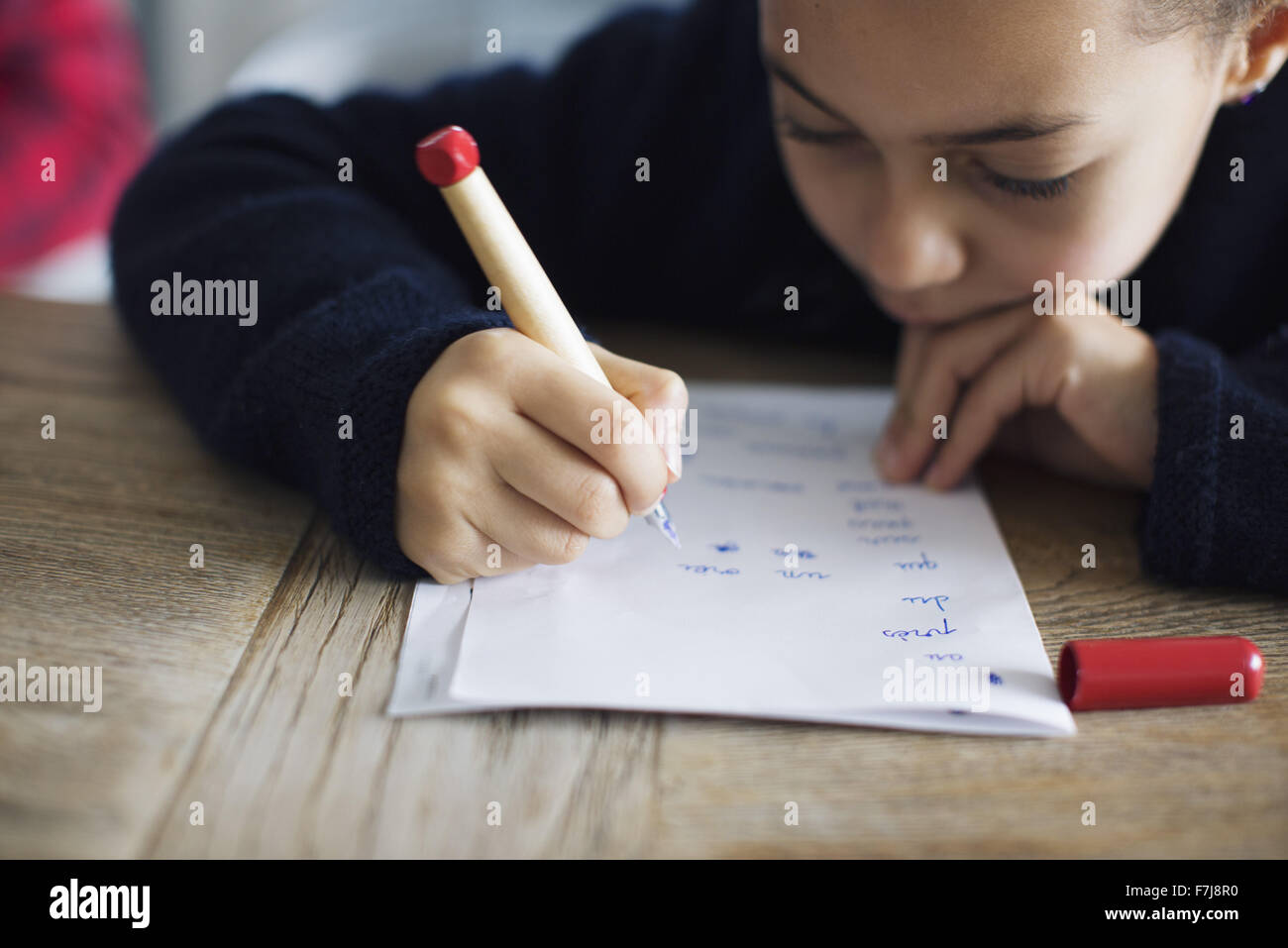 Girl doing homework, close-up Stock Photo - Alamy