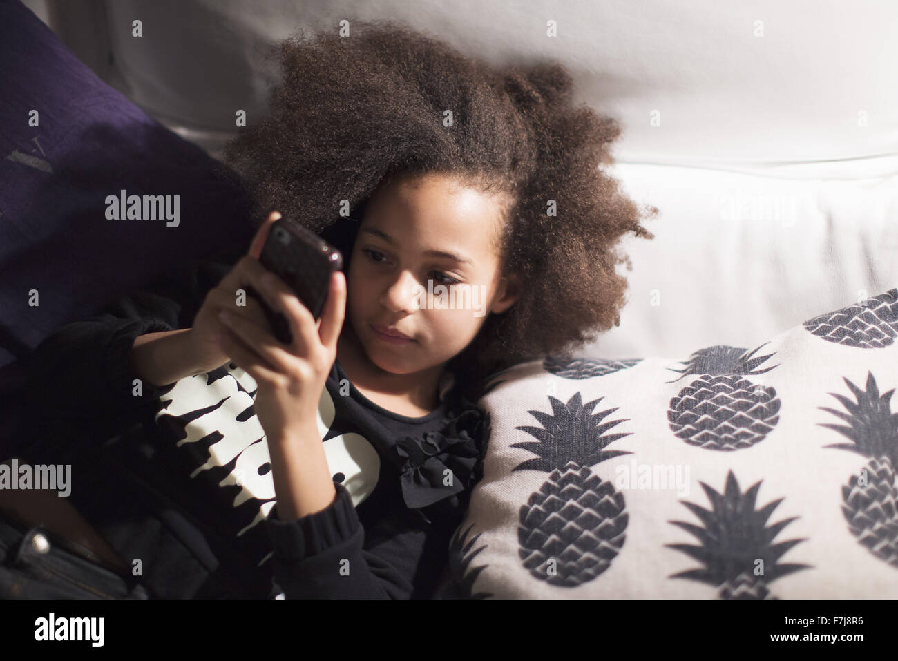 Reclining girl holding smartphone hi-res stock photography and images ...