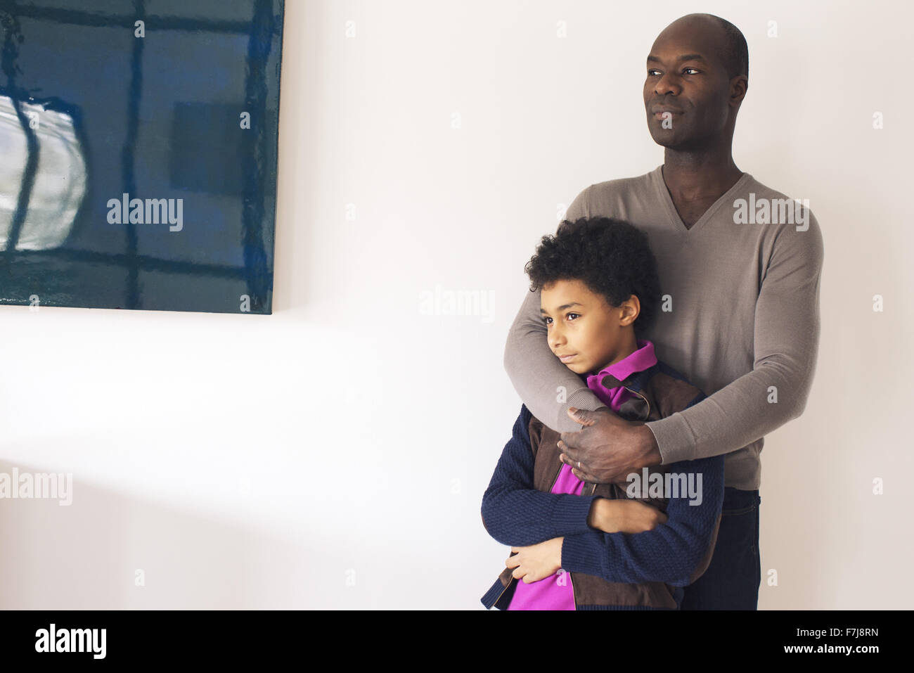 Father embracing son Stock Photo - Alamy
