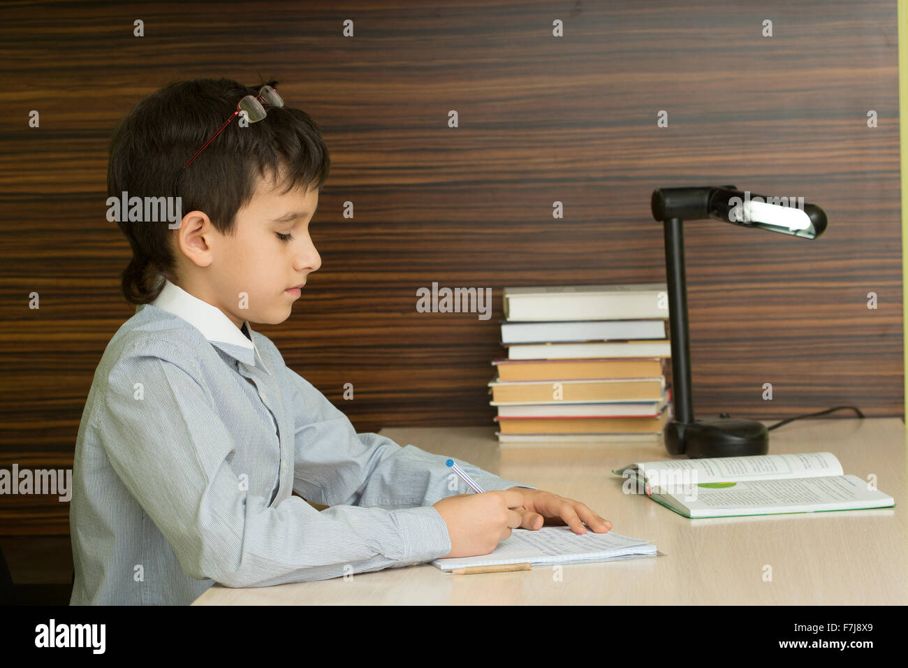 Pupil elementary school does homework Stock Photo - Alamy