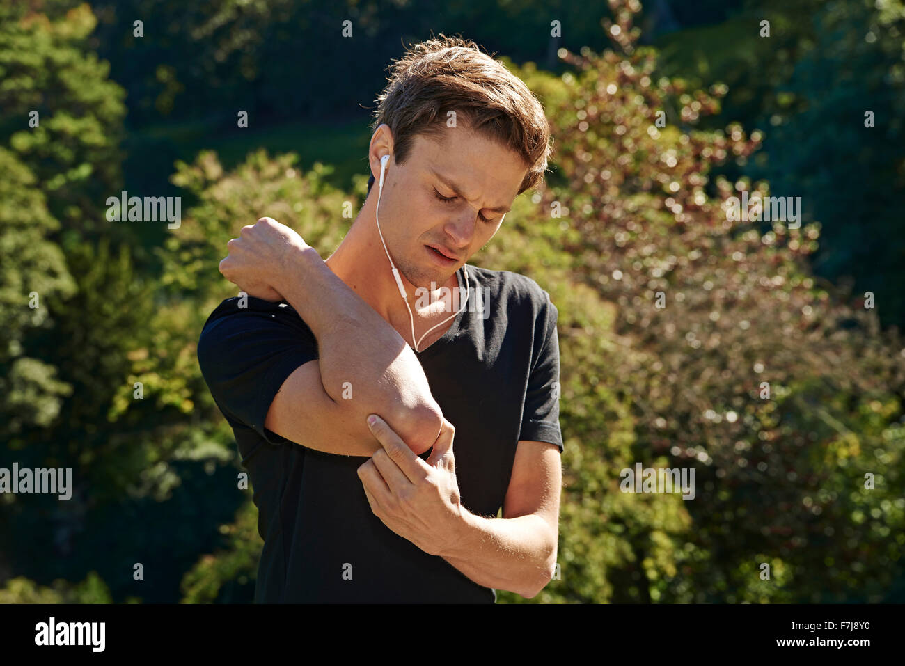 MAN WITH PAINFUL ELBOW Stock Photo - Alamy