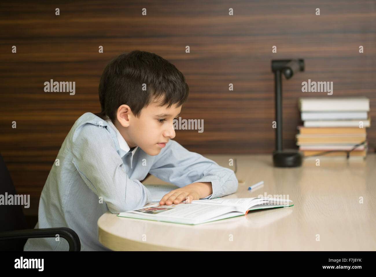 Pupil elementary school does homework Stock Photo - Alamy