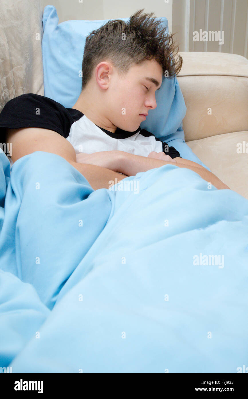 Teen boy sleeping on couch hi-res stock photography and images - Alamy