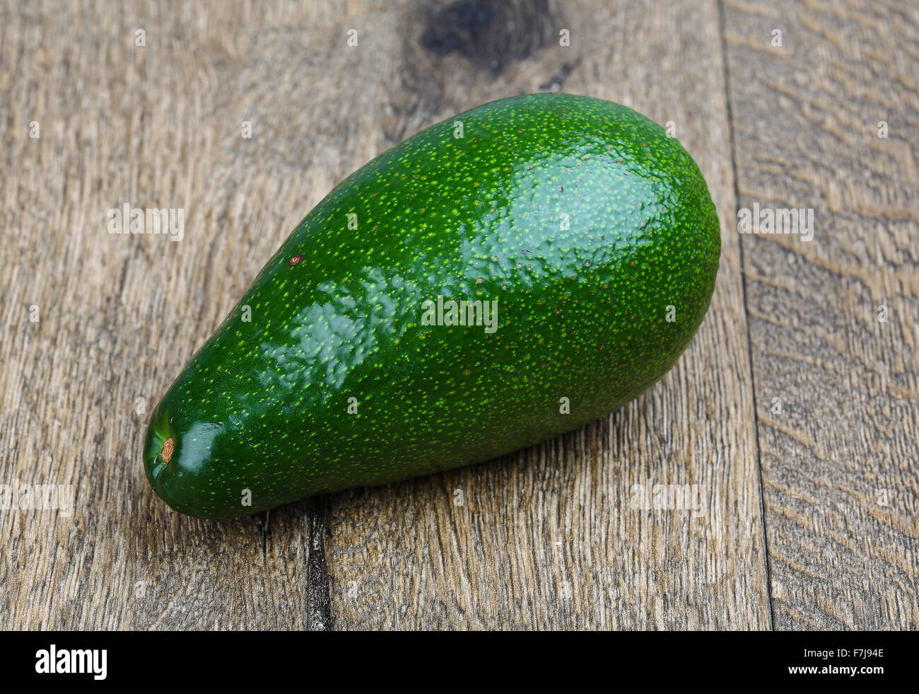 Fresh green ripe avocado on the wood background Stock Photo - Alamy