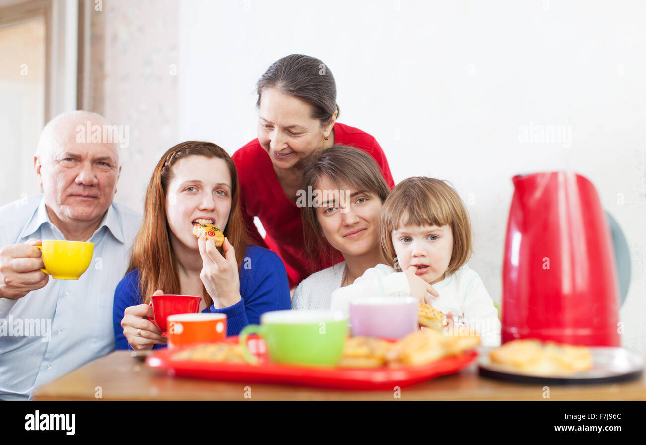 Portrait of happy family posing together over tea at home Stock Photo ...